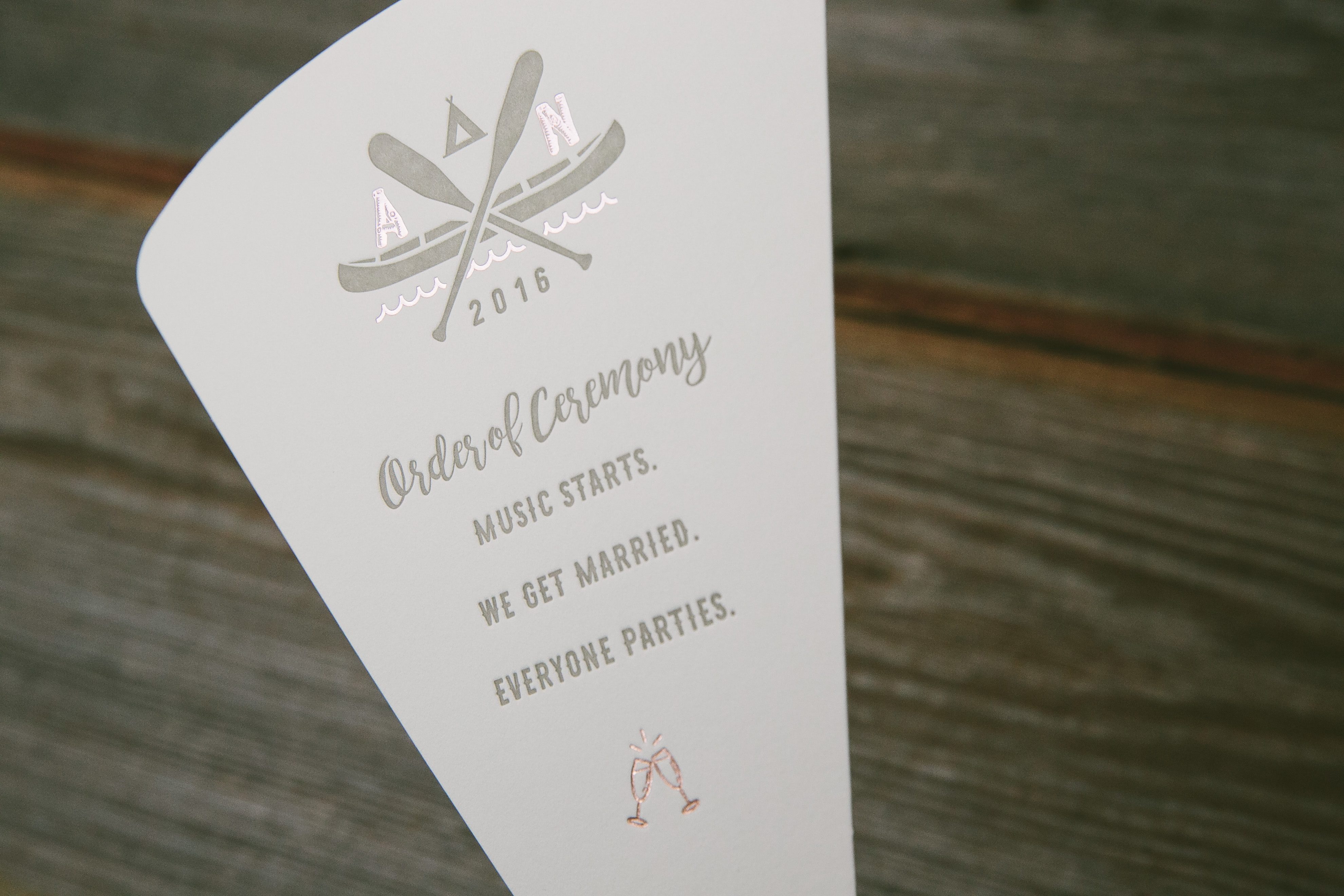 Grommeted paper fan wedding programs letterpress printed by Smock